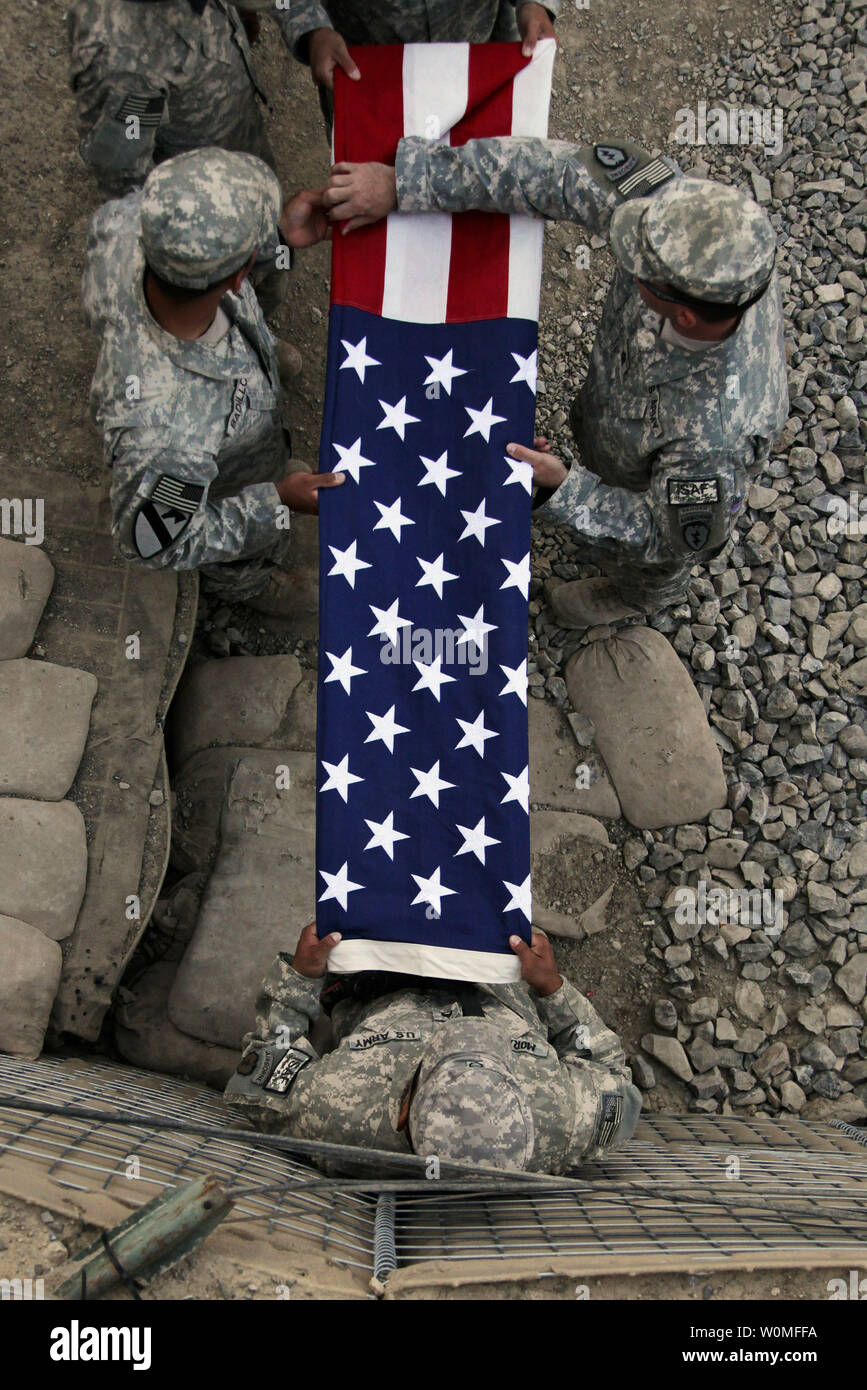 U.S. Army soldiers fold an American flag that will be presented to U.S ...