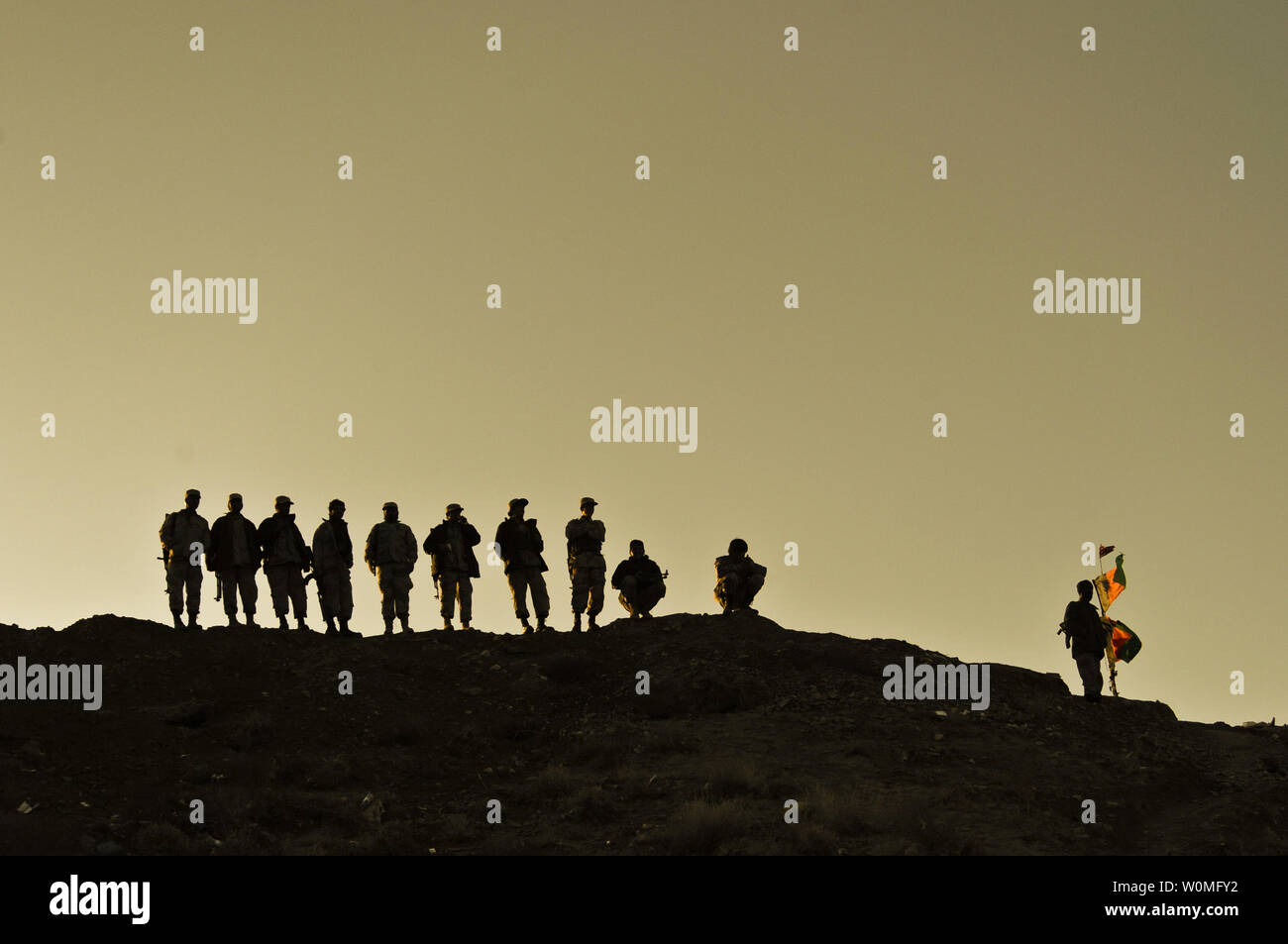 Afghan Border Policemen patrol a hill in the Wam Valley of the Kandahar ...