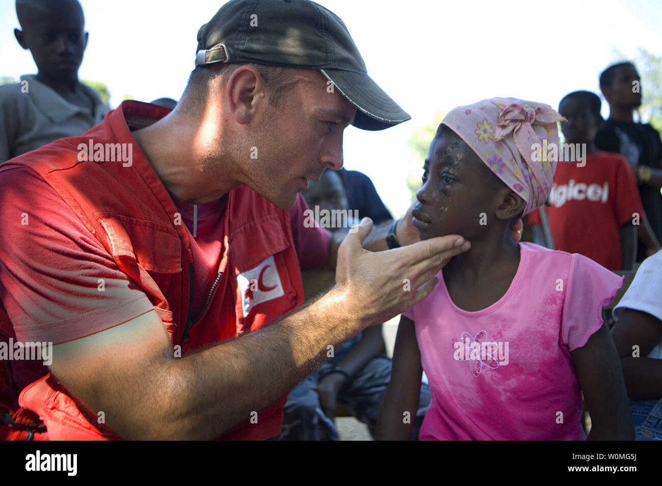 American Red Cross volunteer Matt Marek (L) give medical attention to ...
