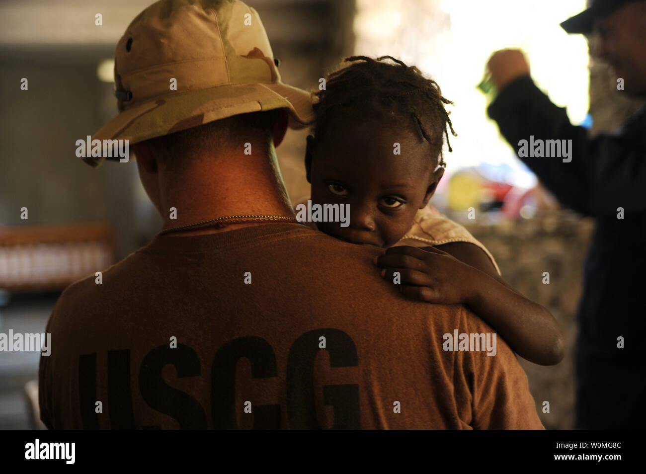A Coast Guardsman from Port Security Unit (PSU) 307 spends time with a ...