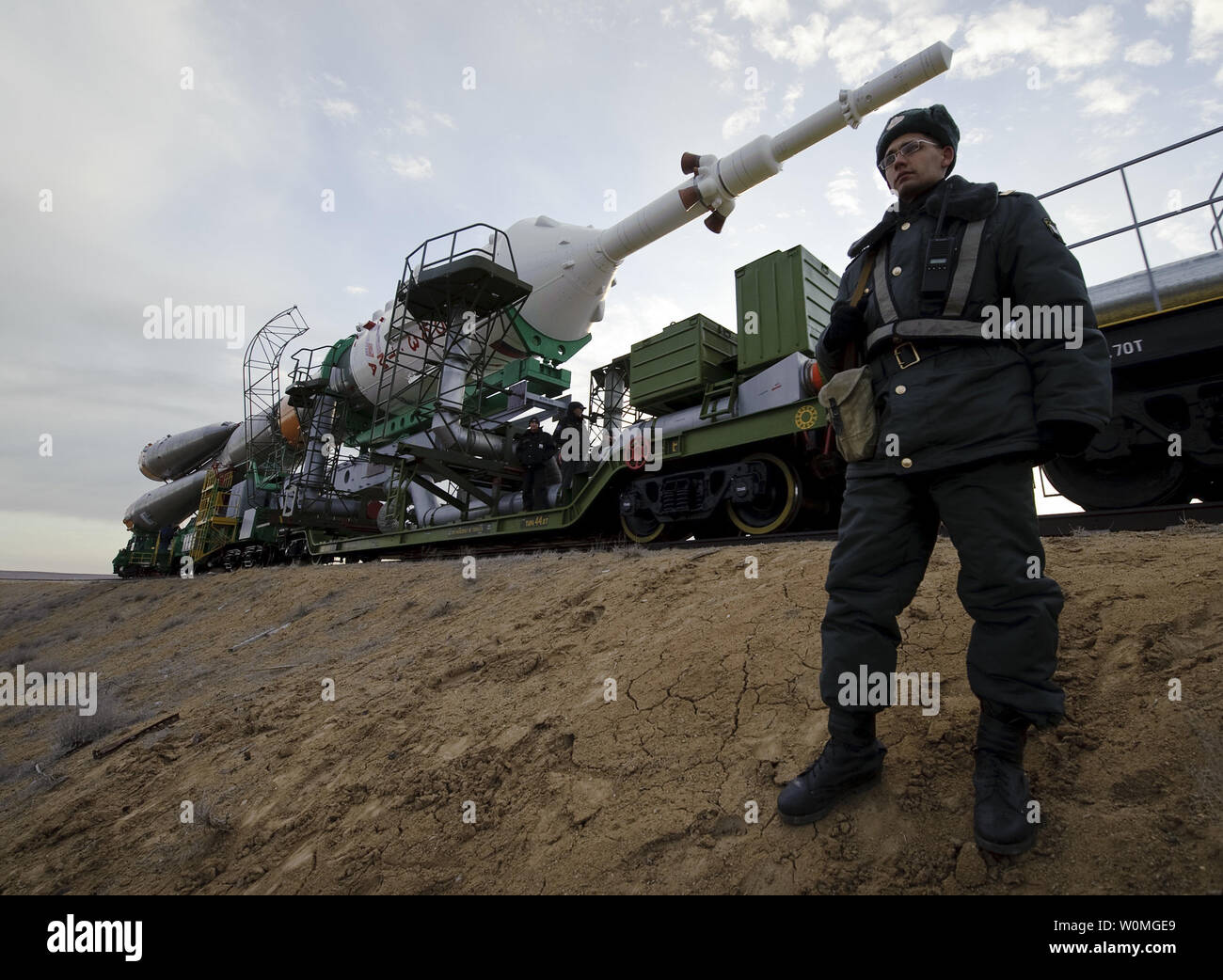 A Russian security officer stands guard as the Soyuz TMA-18 spacecraft ...