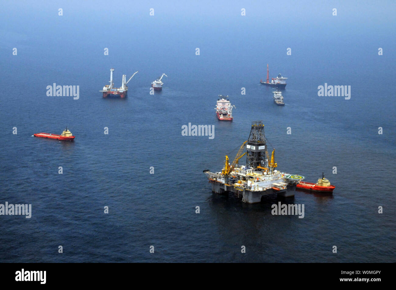 Crews work on May 8, 2010, collect oil near and around the location ...