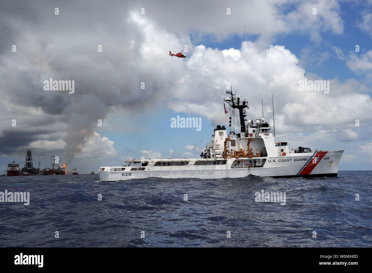A Coast Guard HH-65 Dolphin helicopter flies overhead as the Coast ...