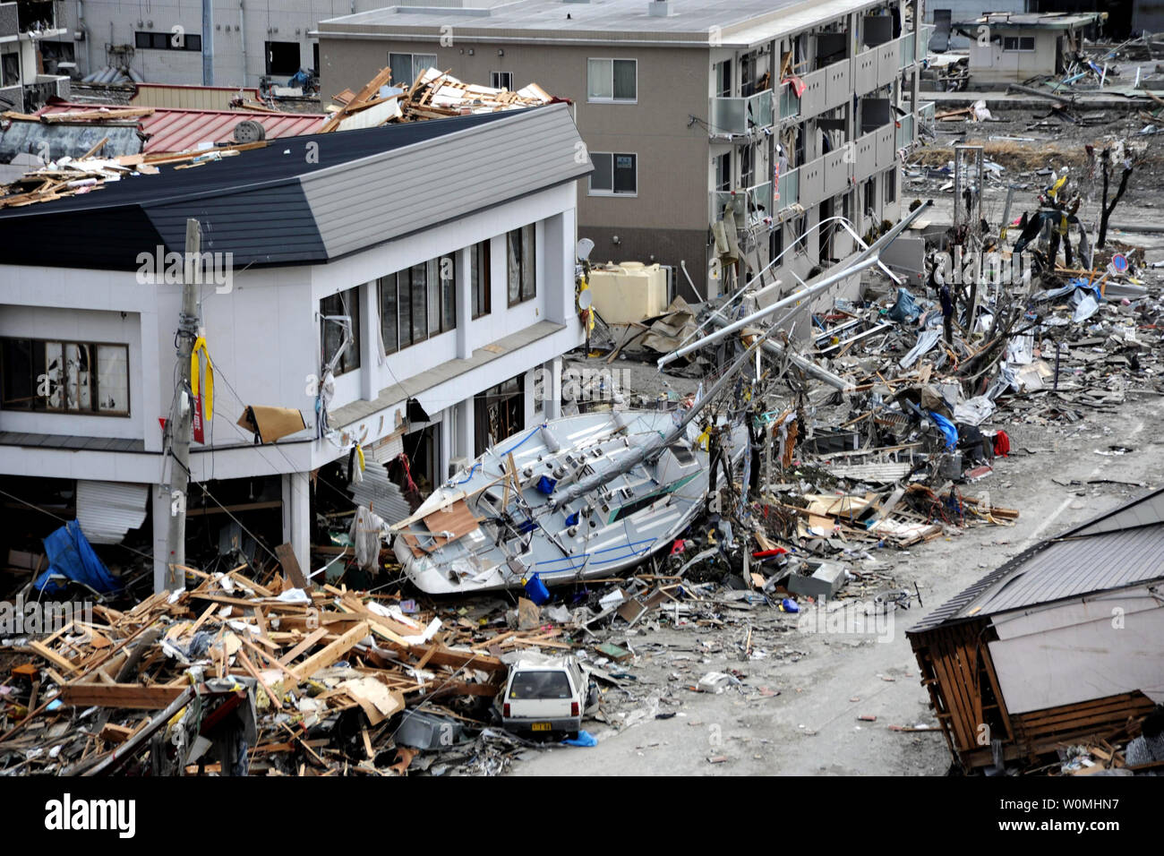 A fishing boat is seen on a street in Ofunato, Japan after being swept ...