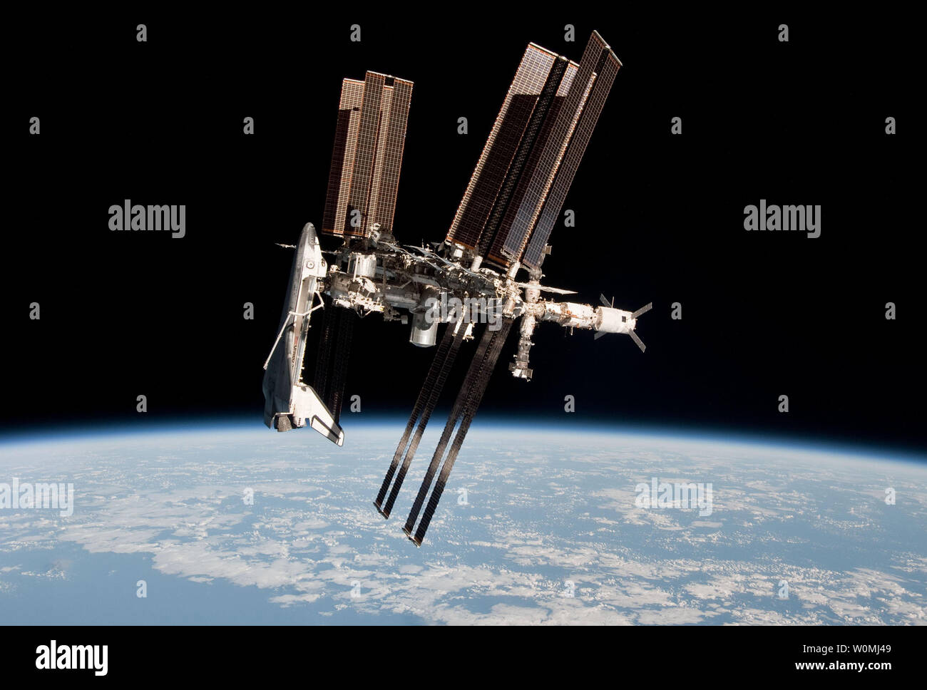 In a newly released photo, the Space Shuttle Endeavour is docked to the ...