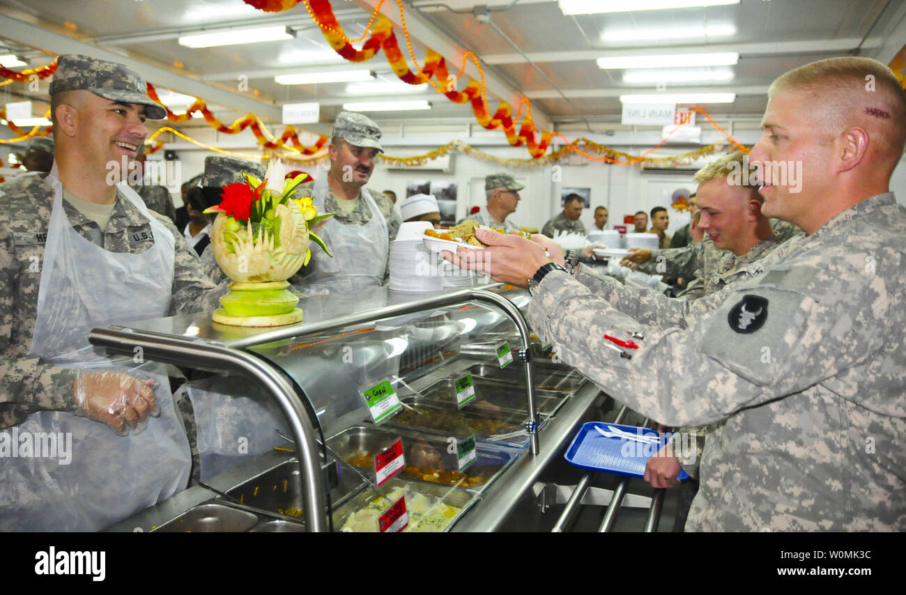 Command Sgt. Maj. Paul Herr serves Thanksgiving dinner to troops of 1st ...