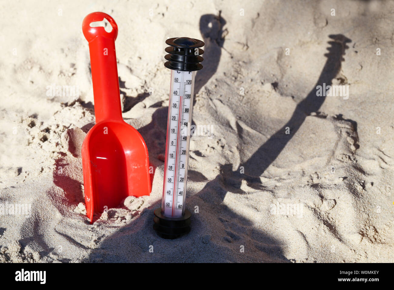 Hot Summer. Thermometer in the sand on the beach Stock Photo - Alamy