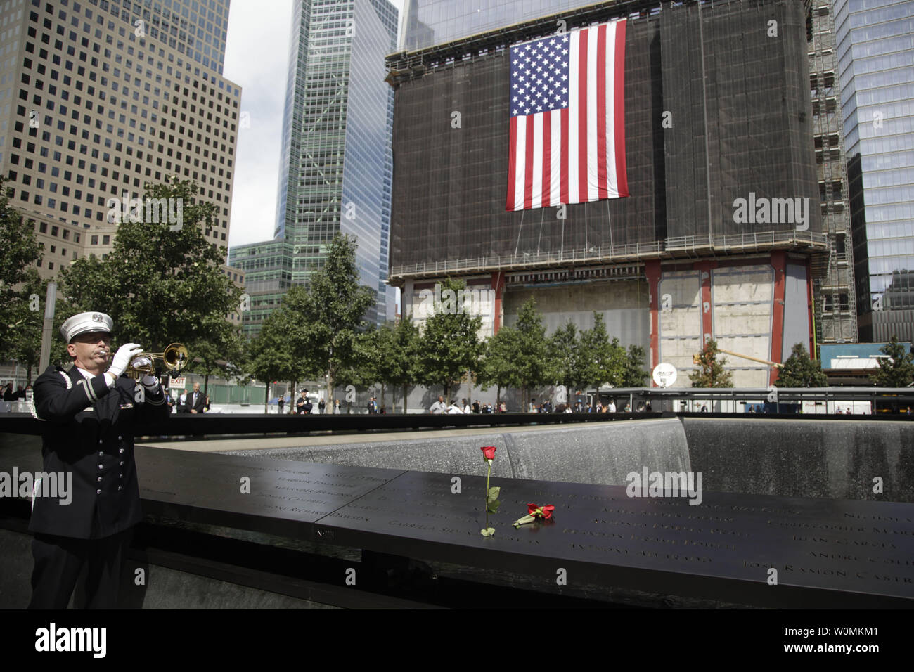 FDNY Capt. Tom Engel of Ladder 133 plays taps during the observances ...