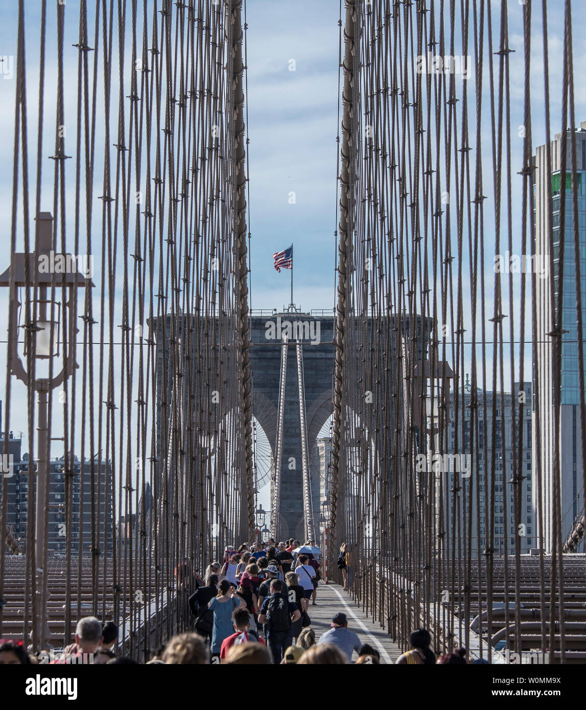 Crowds crossing the pedestrian walkway on the Brooklyn Bridge in New ...