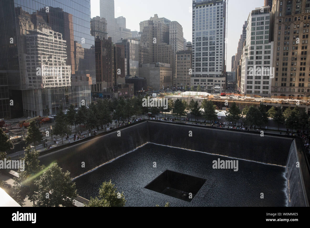 People gather around the South Tower pool during memorial ceremonies ...