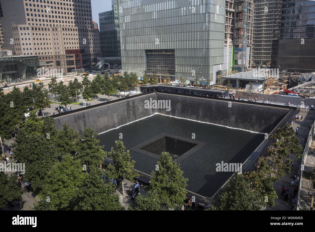 People gather around the North Tower pool during memorial ceremonies ...