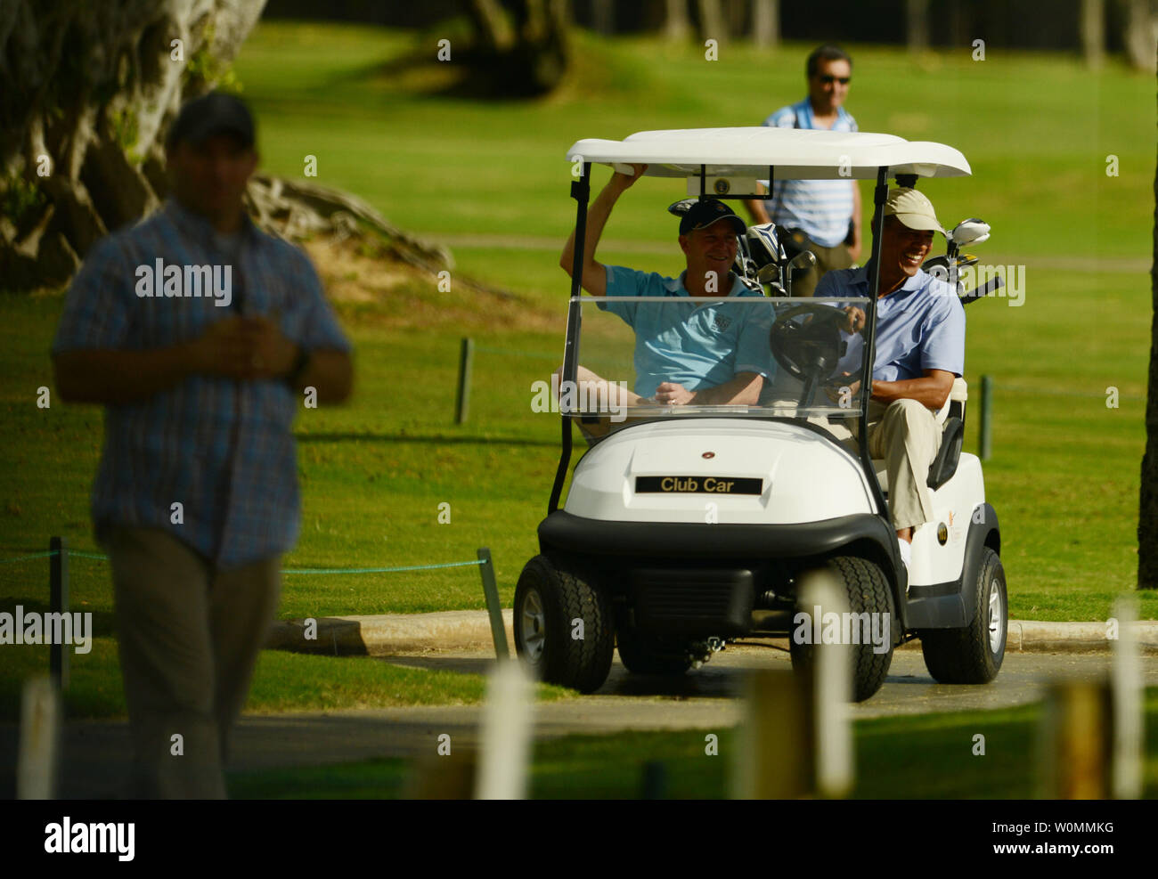 President Barack Obama rides in a gold cart with the Prime Minister of ...
