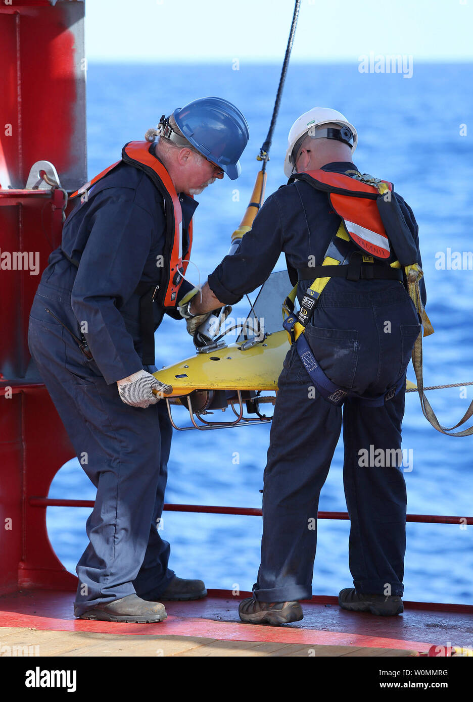 Phoenix International personnel deploy a "towed pinger locator" off the ...