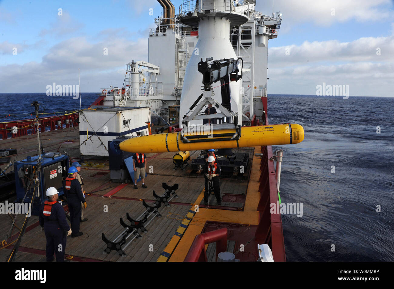 Operators aboard the Australian Defense Vessel Ocean Shield move the U ...