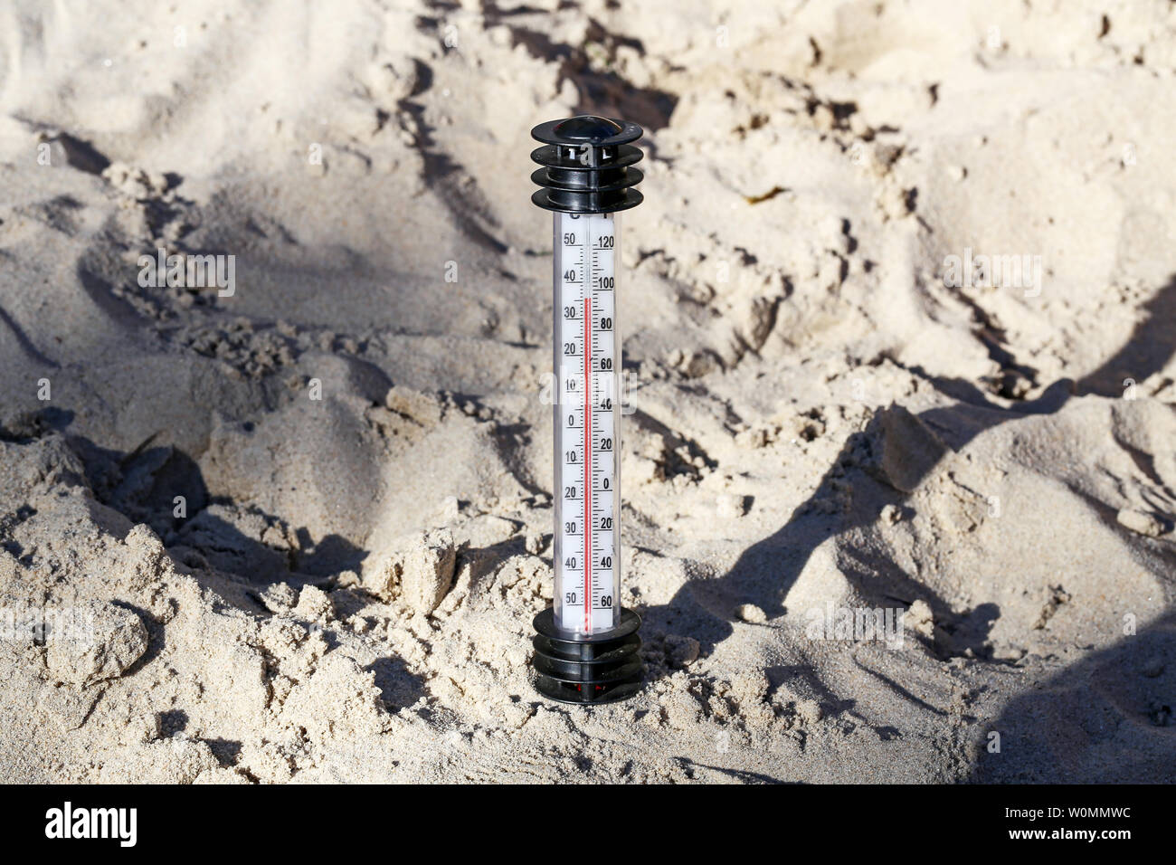 Hot Summer. Thermometer in the sand on the beach Stock Photo - Alamy