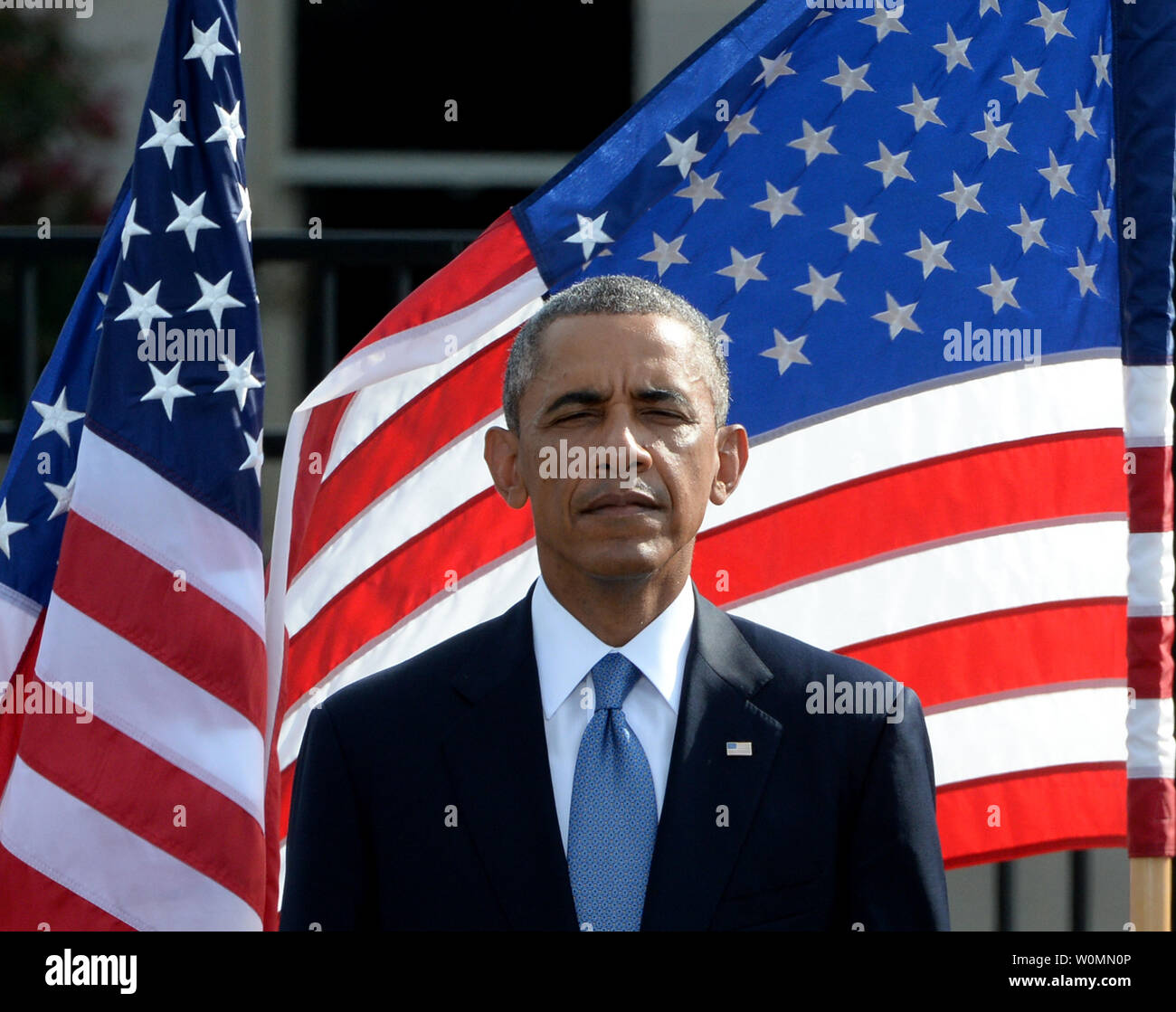 Flags wave as President Barack Obama attends the memorial commemoration ...