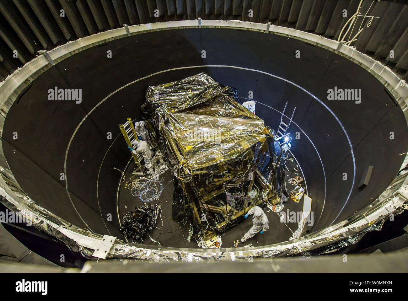 Engineers work with the Integrated Science Instrument Module for the ...