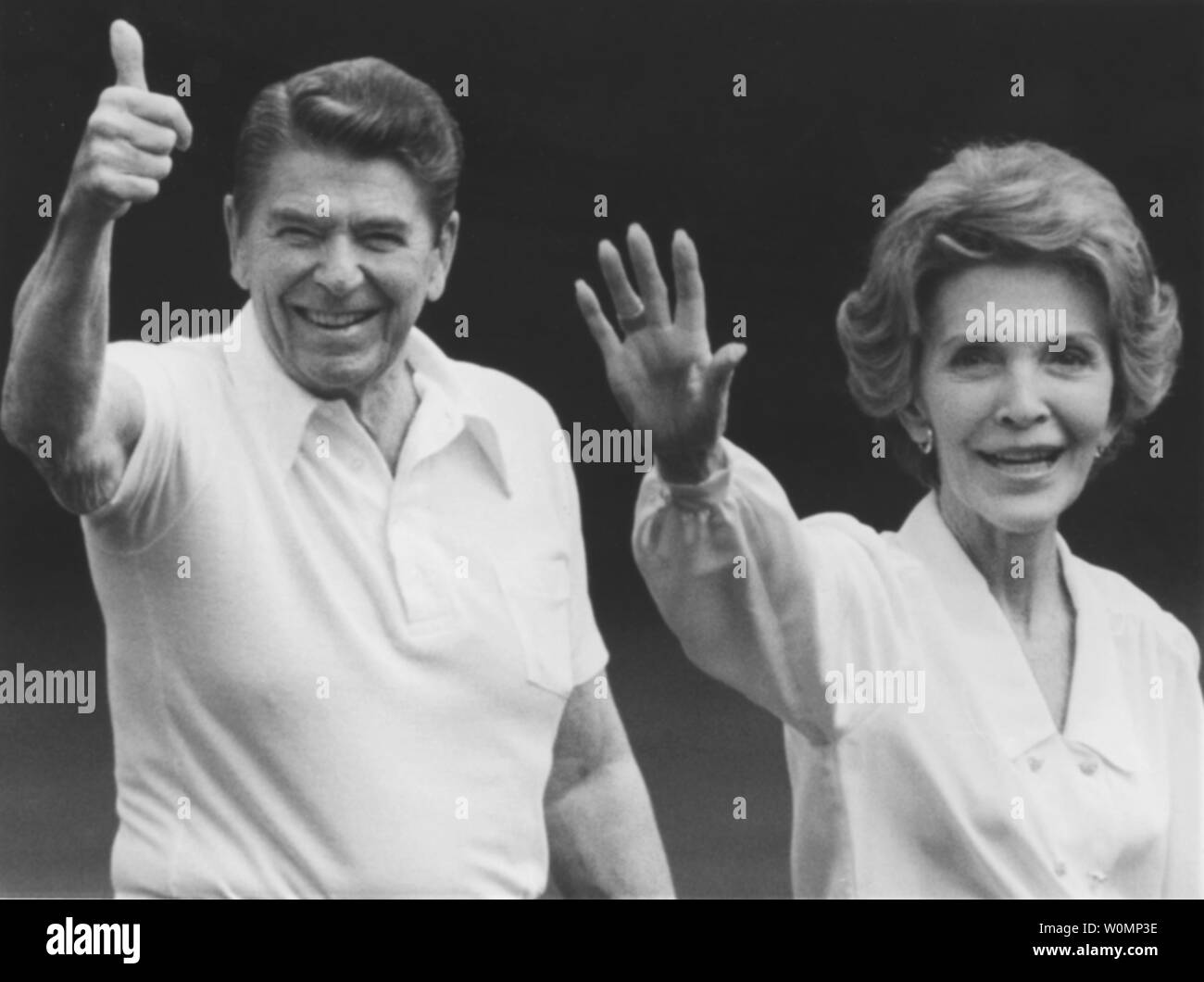 In this file photo, President Reagan gives a "thumbs-up" as he and ...