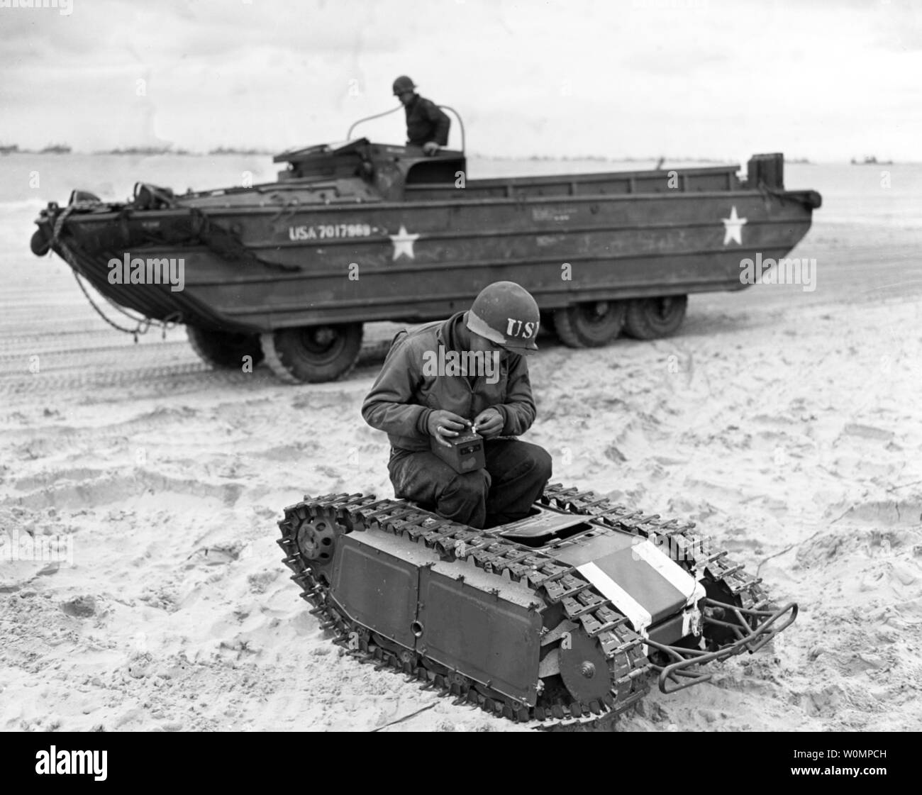 A member of the the U.S. Navy's Second Beach Battalion disassembles a ...