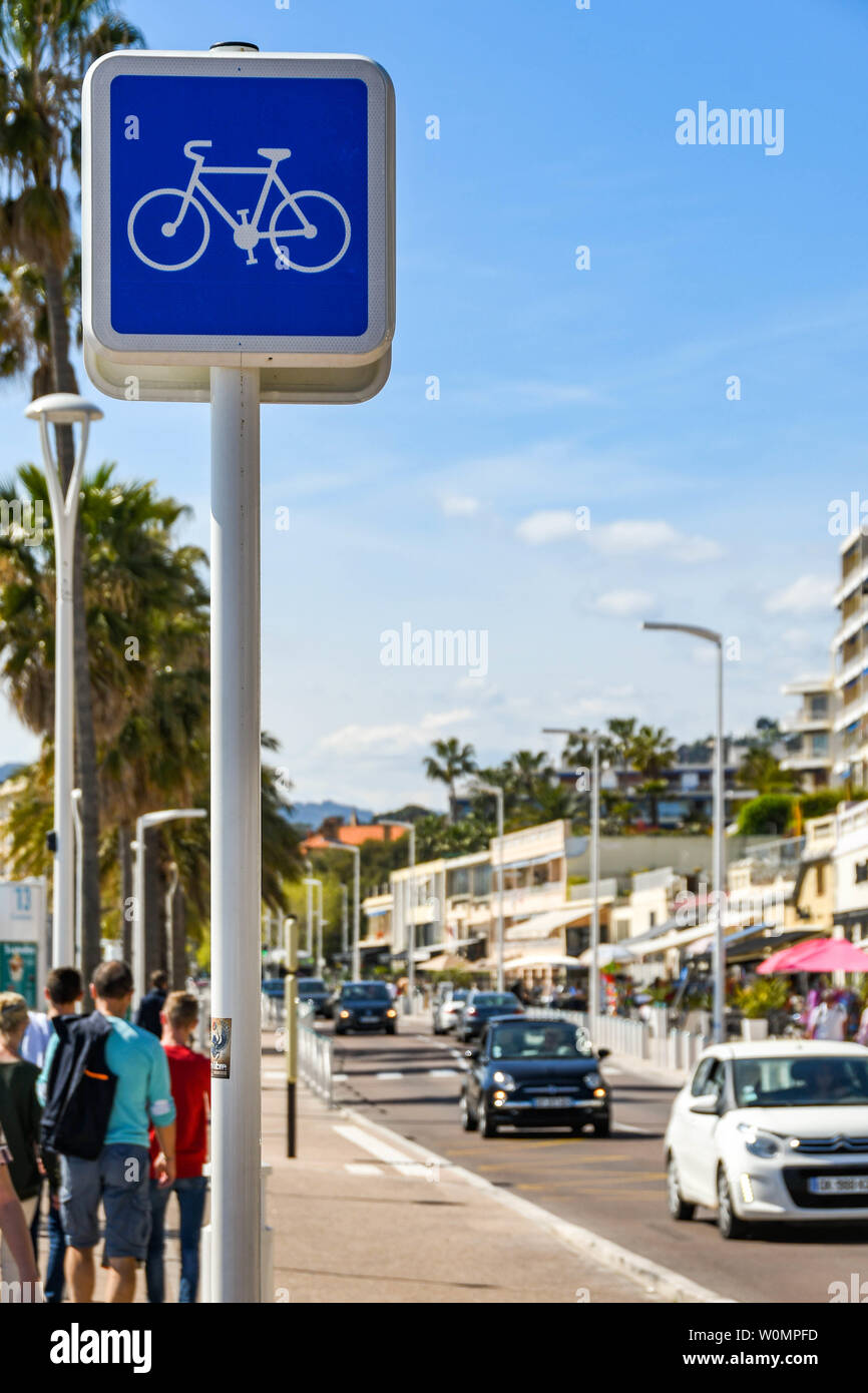 CANNES, FRANCE - APRIL 2019: Sign above a cycle lane alongside a road ...