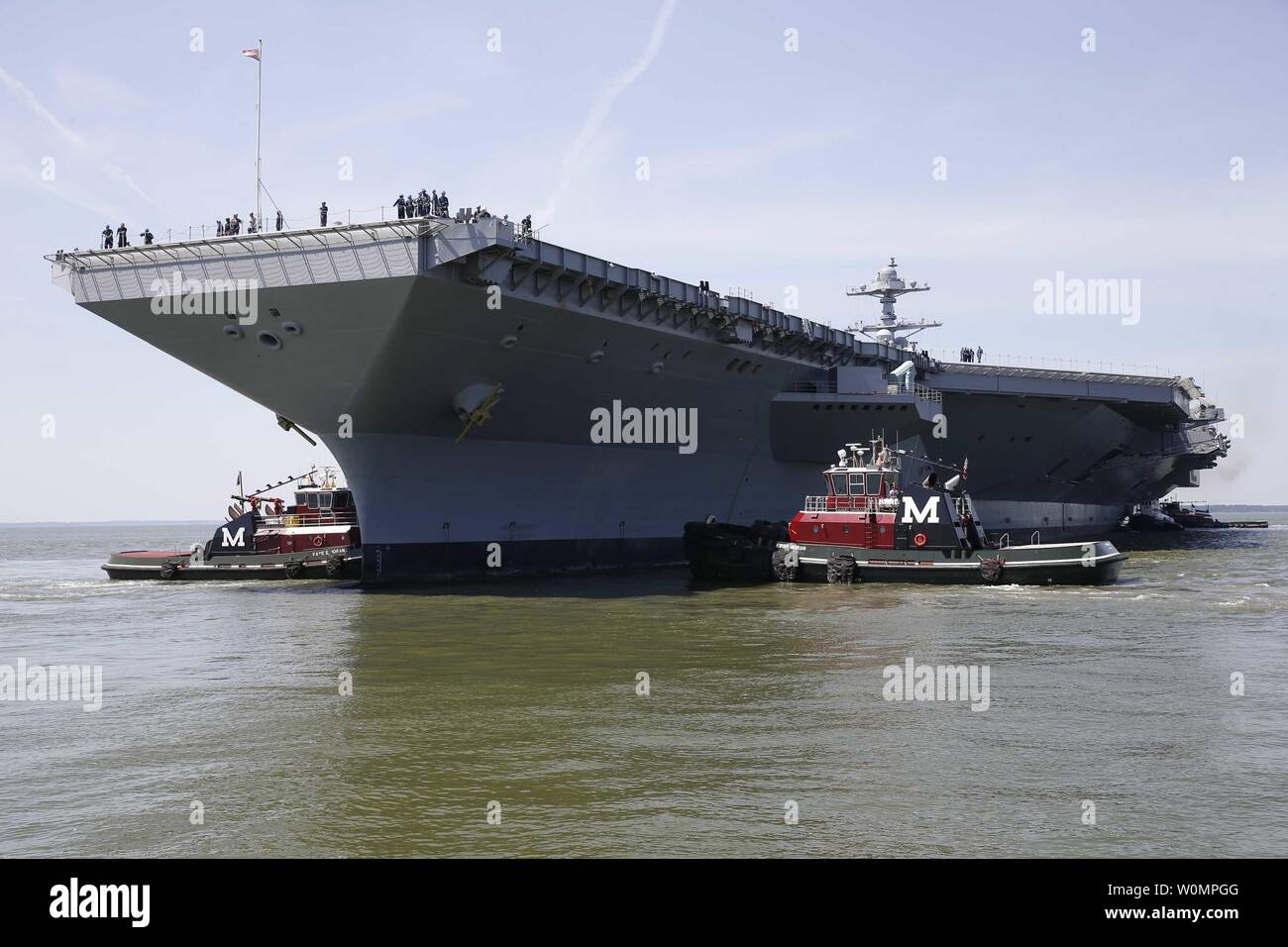 Pre-Commissioning Unit Gerald R. Ford (CVN 78) is maneuvered by tug ...