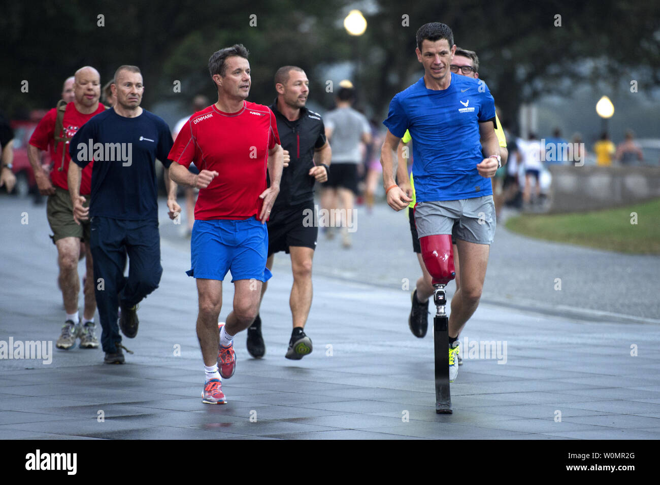 Crown Prince Frederik of Denmark, front left, leads a run with retired ...