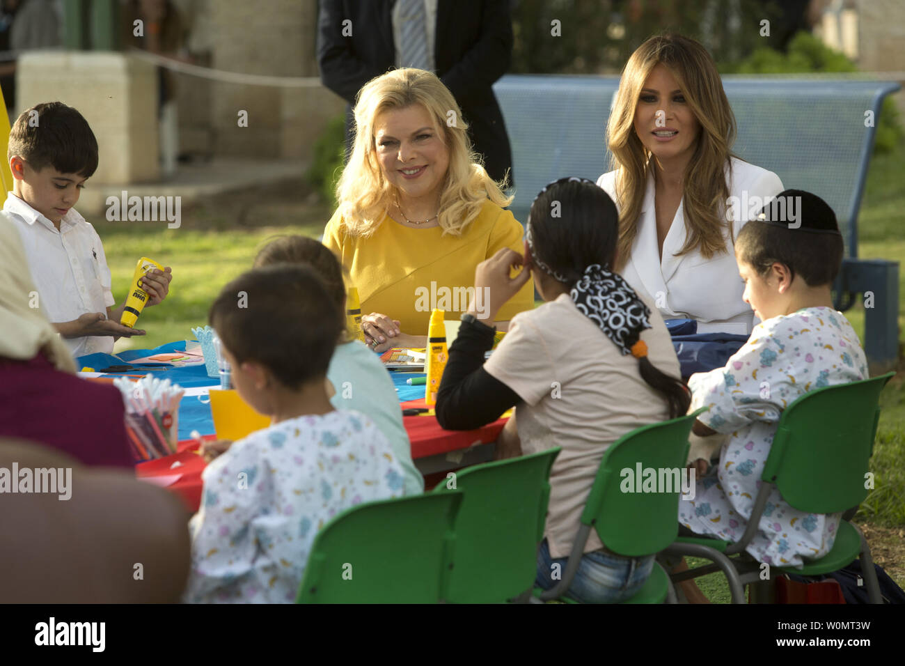 US first lady Melania Trump, right, and Sara Netanyahu talk to children ...