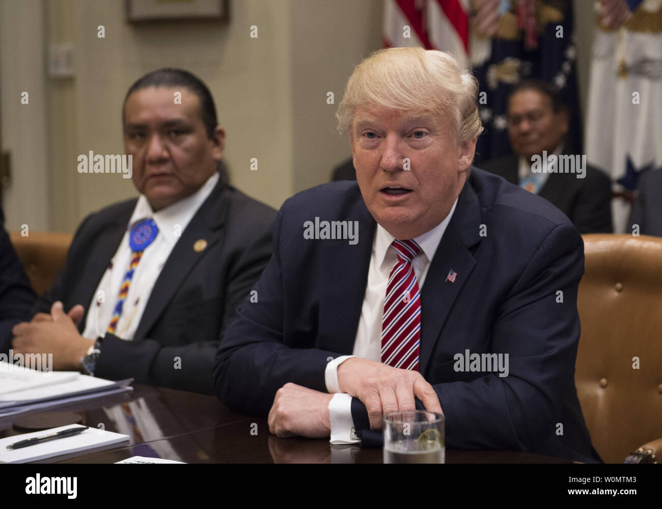 President Donald Trump speaks next to Southern Ute Councilman Kevin ...