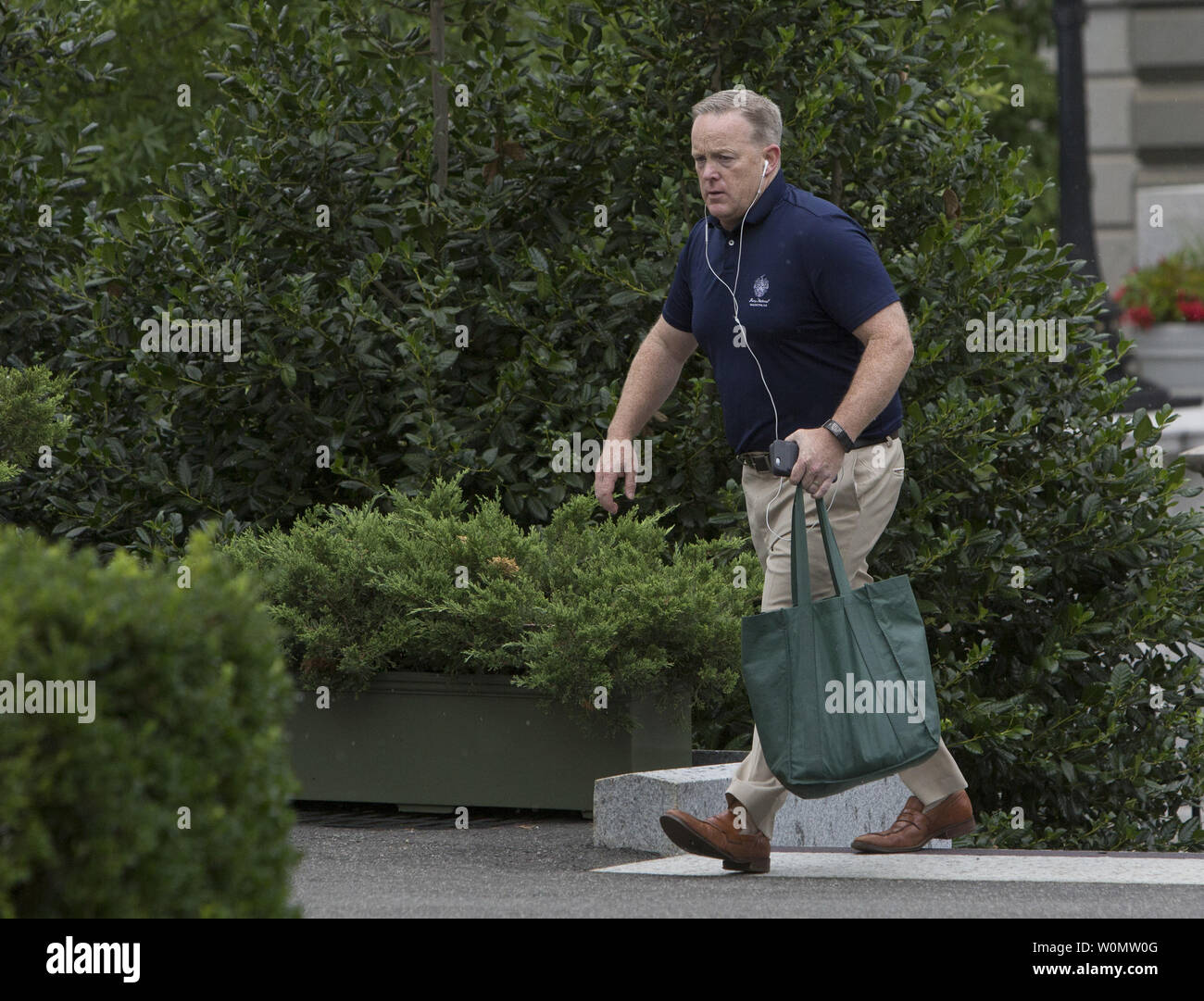 Outgoing White House Spokesman Sean Spicer walks into the West Wing of ...