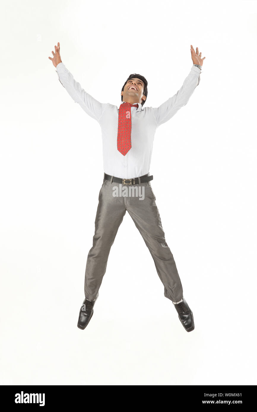 Businessman jumping in air Stock Photo - Alamy