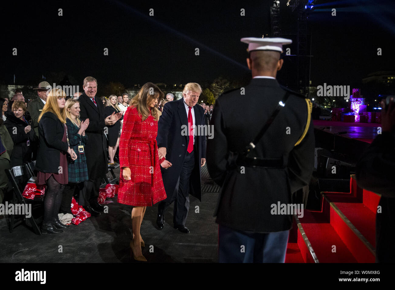 U.S. President Donald Trump and first lady Melania Trump take the stage ...