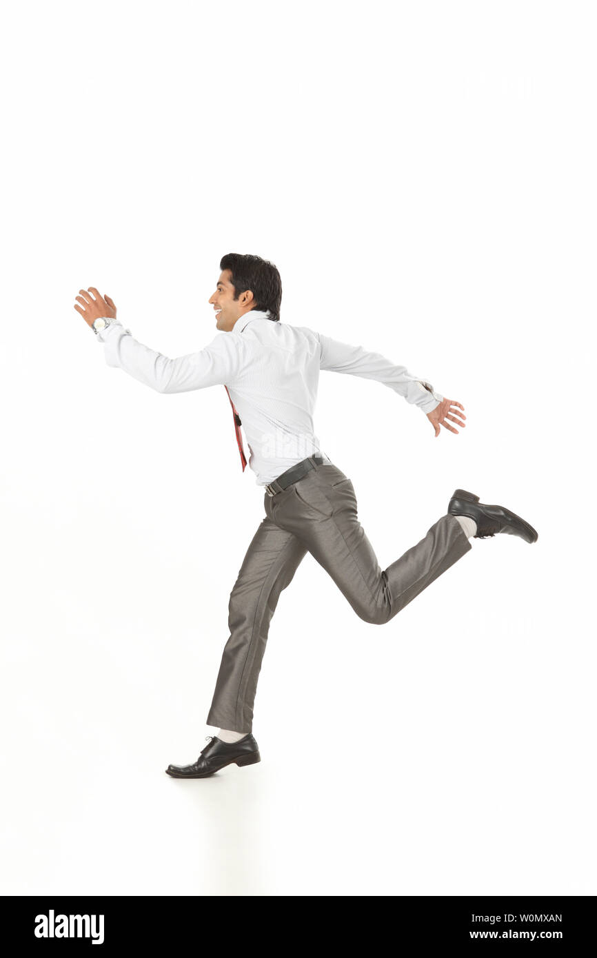 Indian young businessman running Stock Photo - Alamy