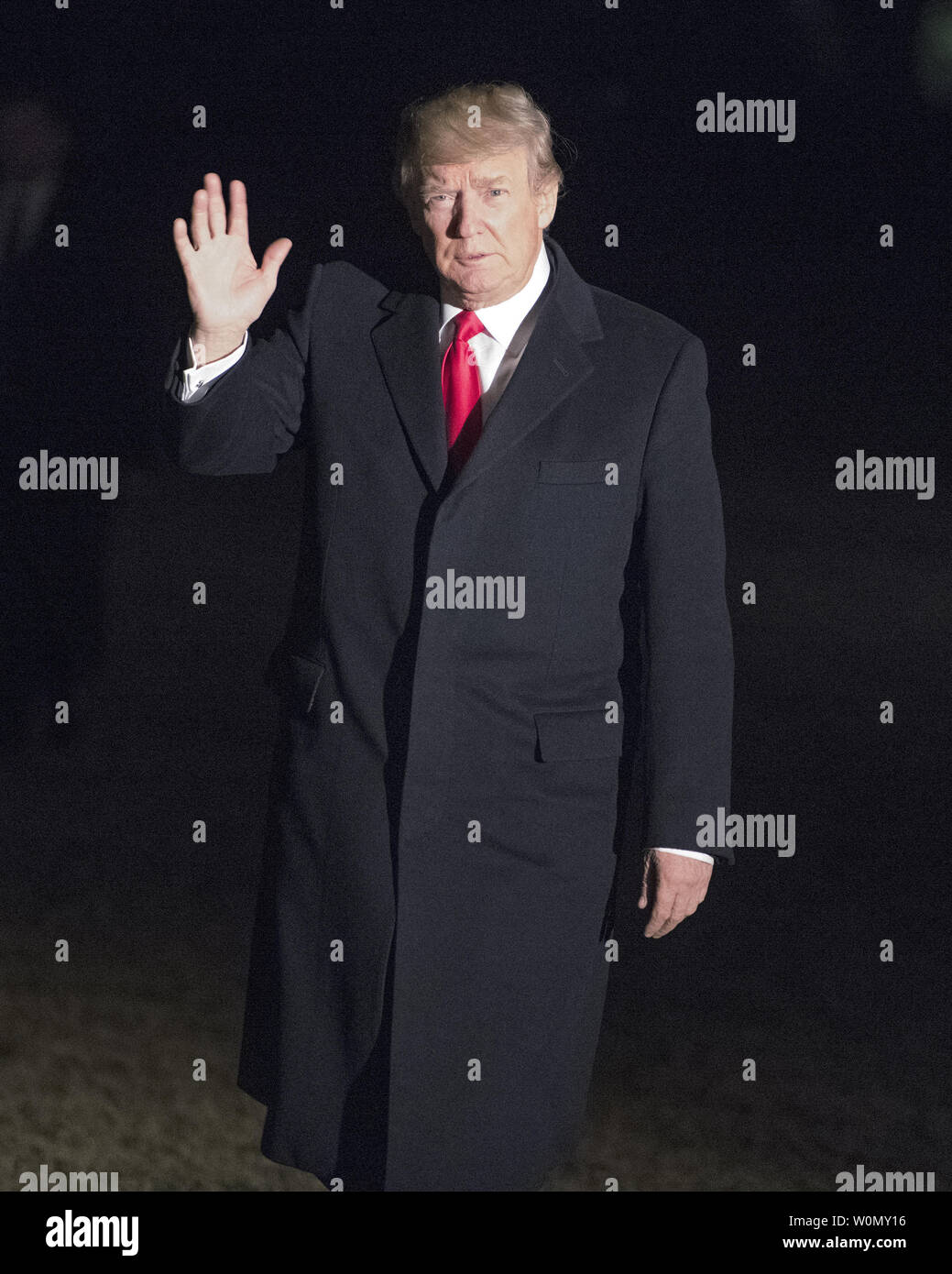 United States President Donald J. Trump waves as he returns to the ...