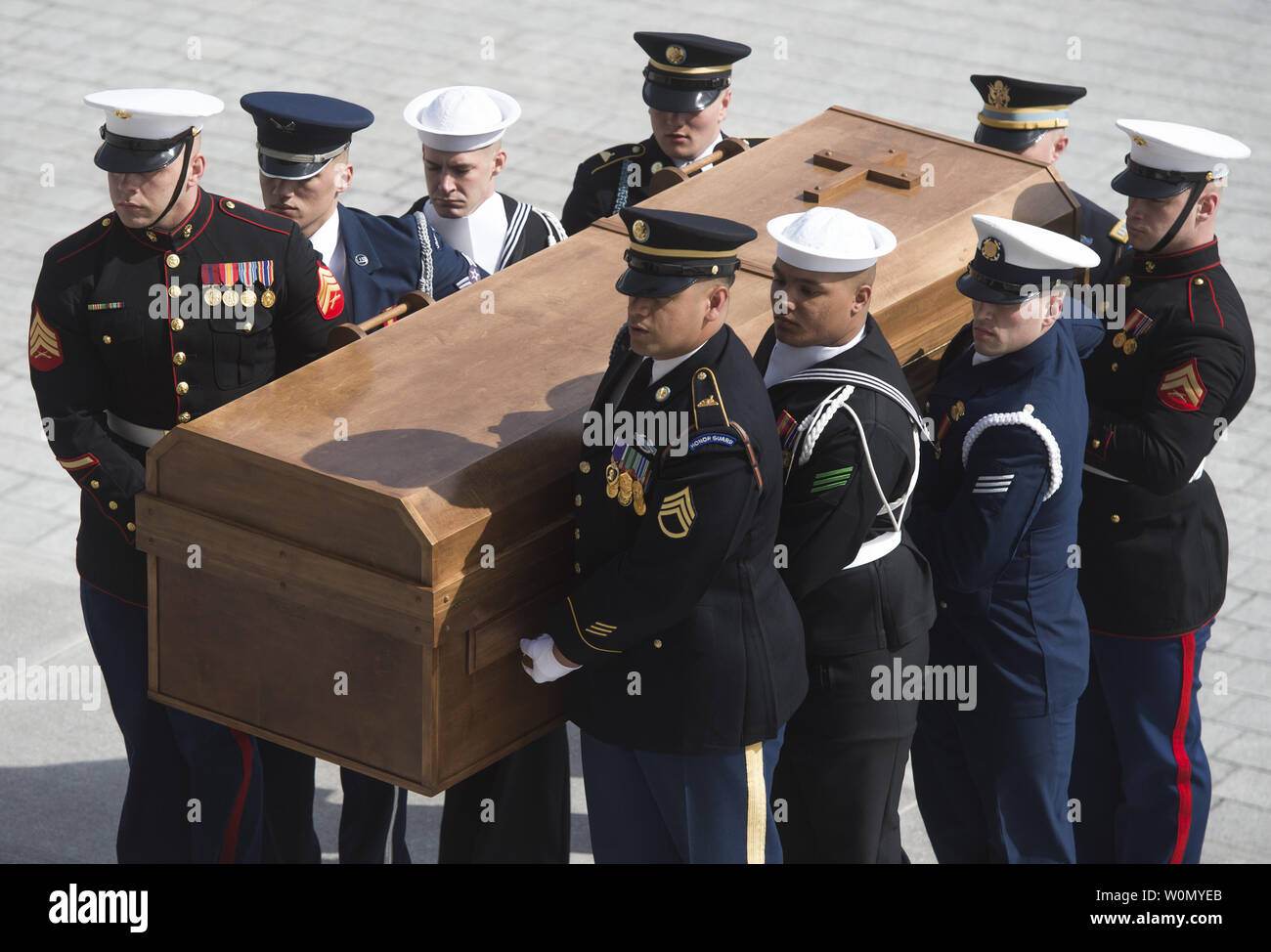 A Military Honor Guard carries the casket of Reverend Billy Graham as ...
