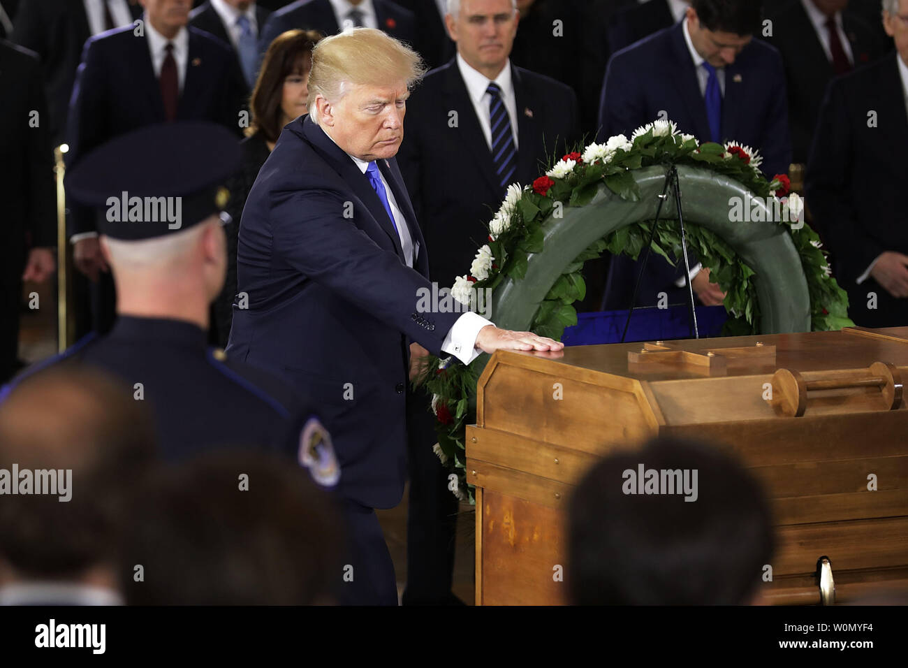 U.S. President Donald Trump touches the casket of Christian evangelist ...