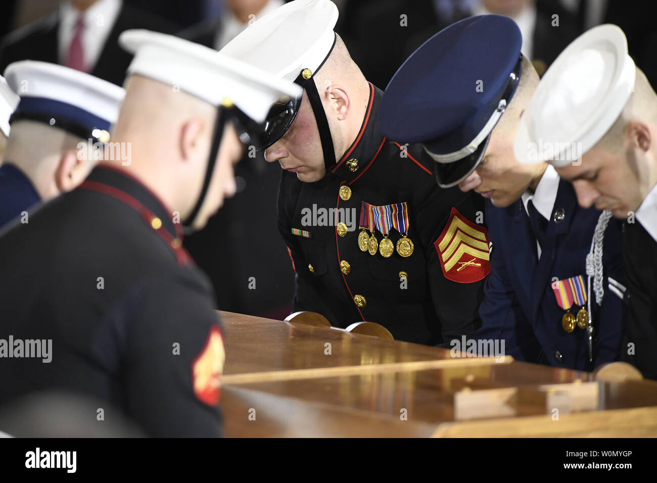 The casket carrying the Reverend Billy Graham is carried into the ...