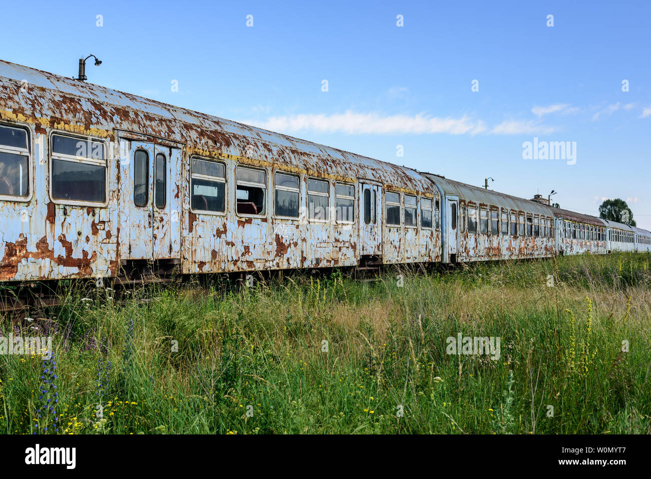 Old rusty railway wagon whit broken windows. Old abandoned track ...