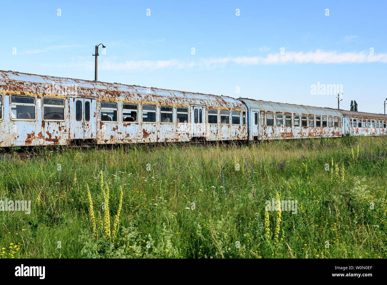 Old rusty railway wagon whit broken windows. Old abandoned track ...