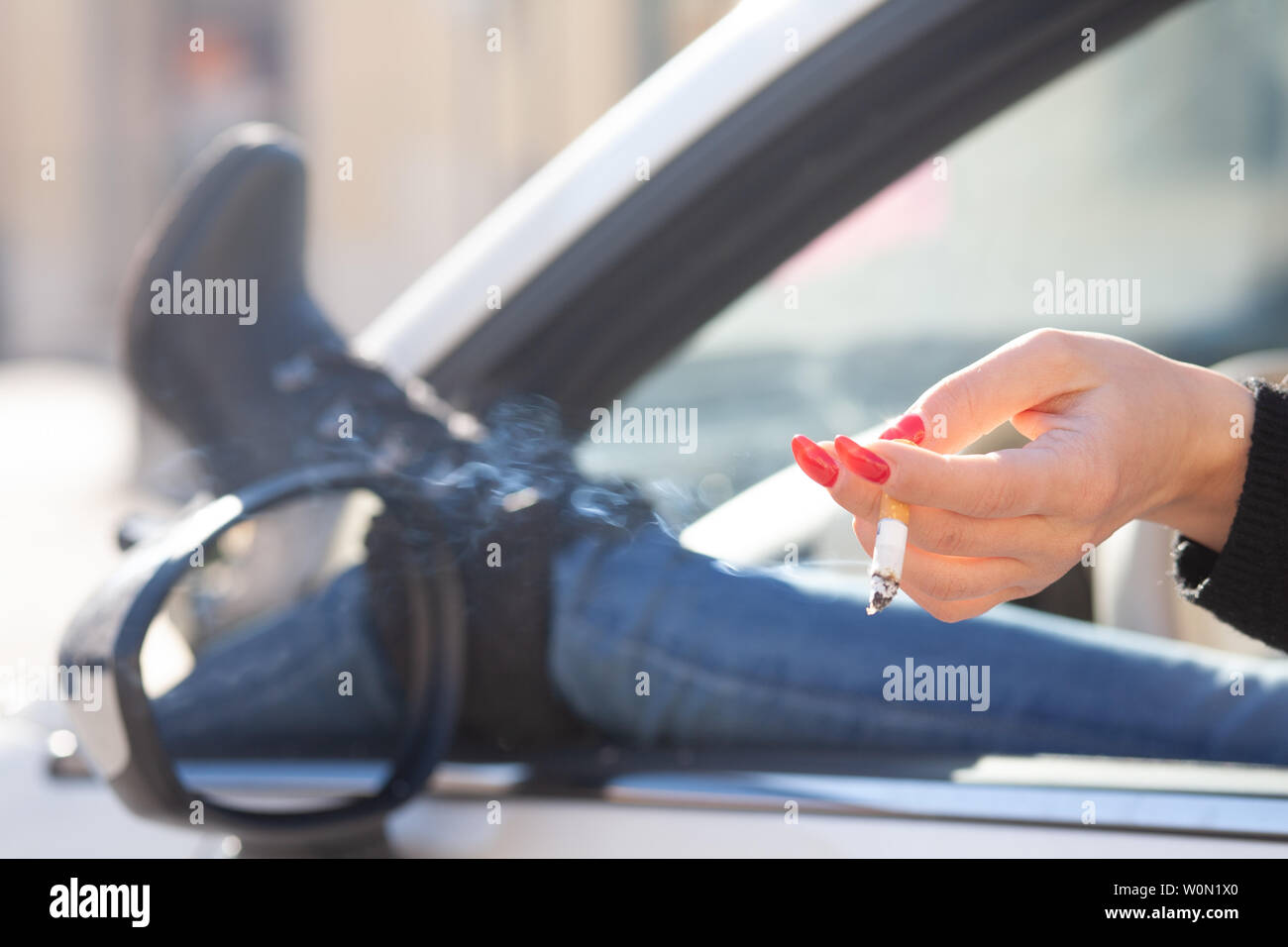 Blond female smoking cigarette hi-res stock photography and images - Alamy