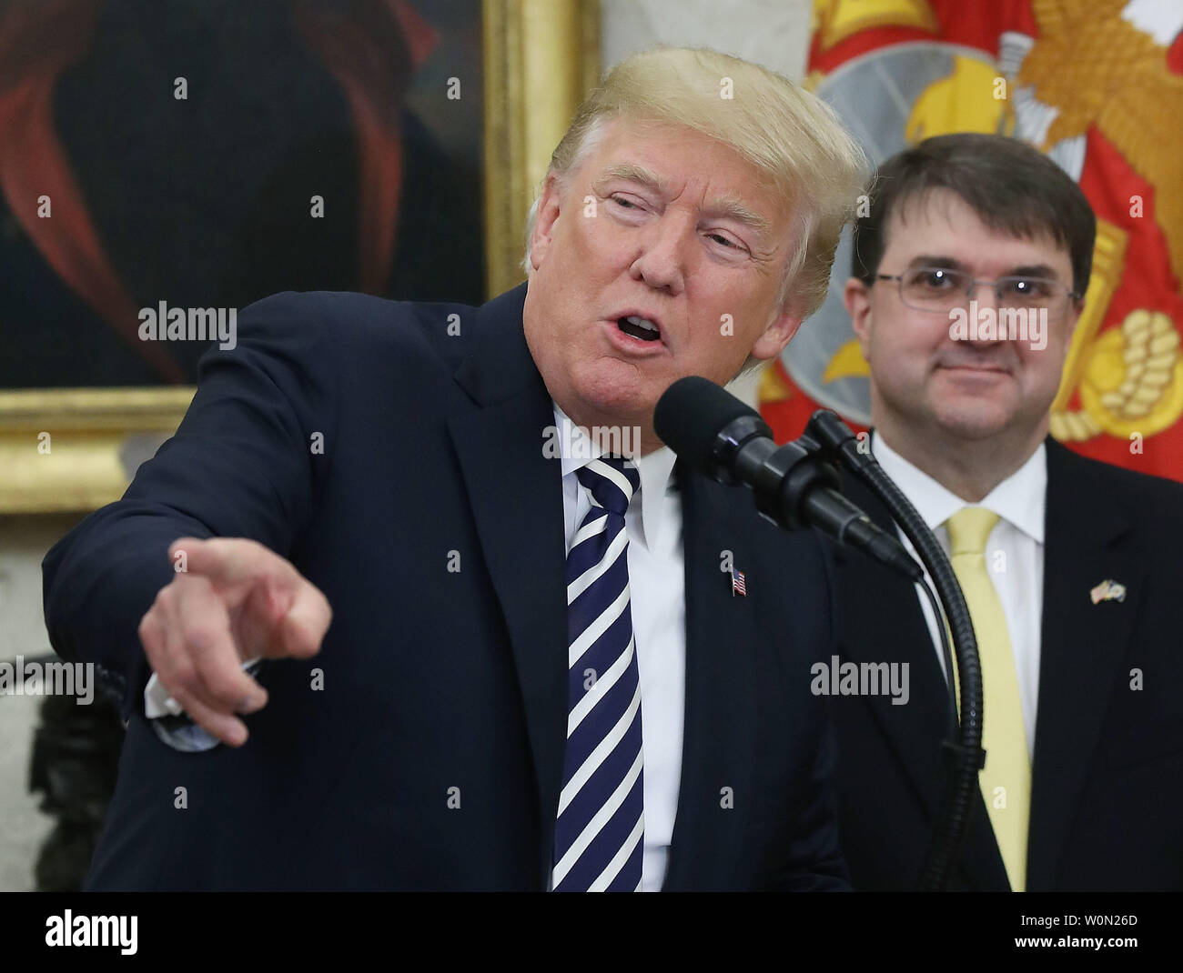 U.S. President Donald Trump (L) speaks during a swearing-in ceremony ...