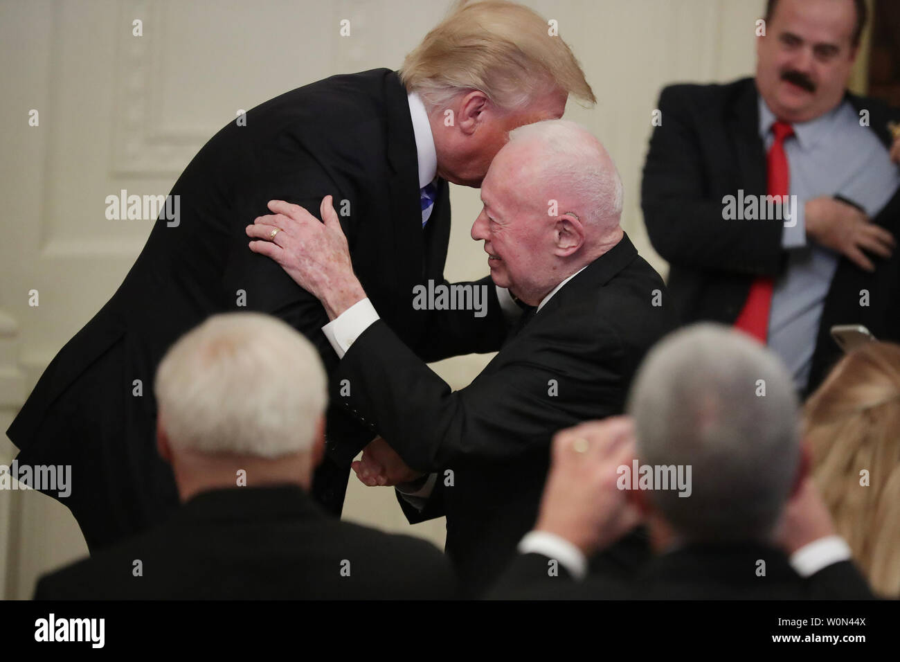 U.S. President Donald Trump shakes hands with former Commandant of the ...