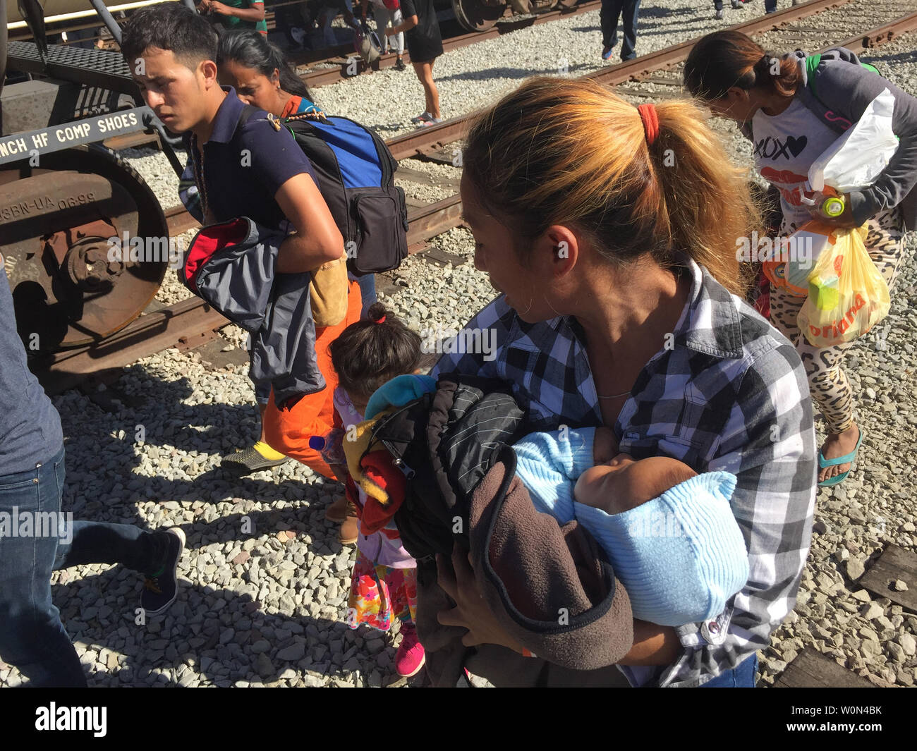 A migrant woman clutches her baby moments before US Customs and Border ...