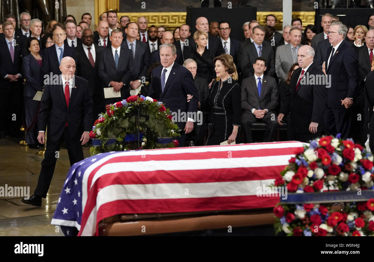 Former President George W. Bush, former first lady Laura Bush, walk ...