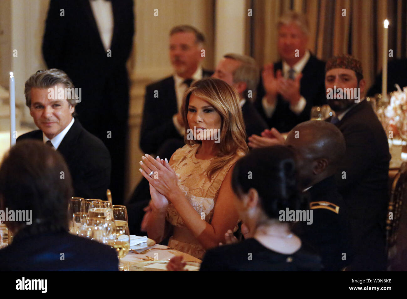 First lady Melania Trump applauds during a dinner on the eve of the ...