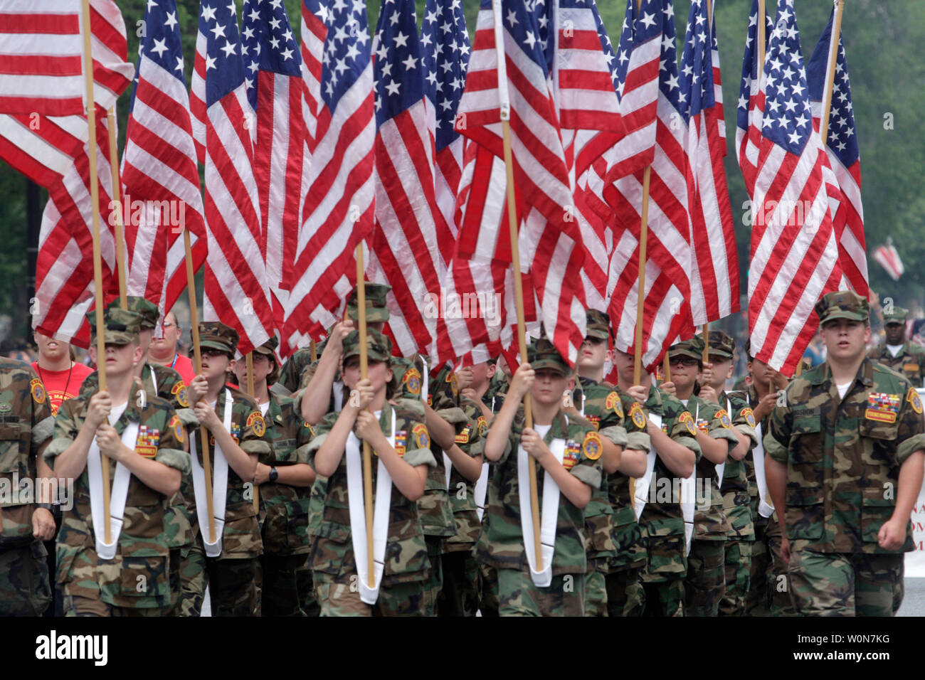 Young marchers carry American flags during the Memorial Day parade in ...
