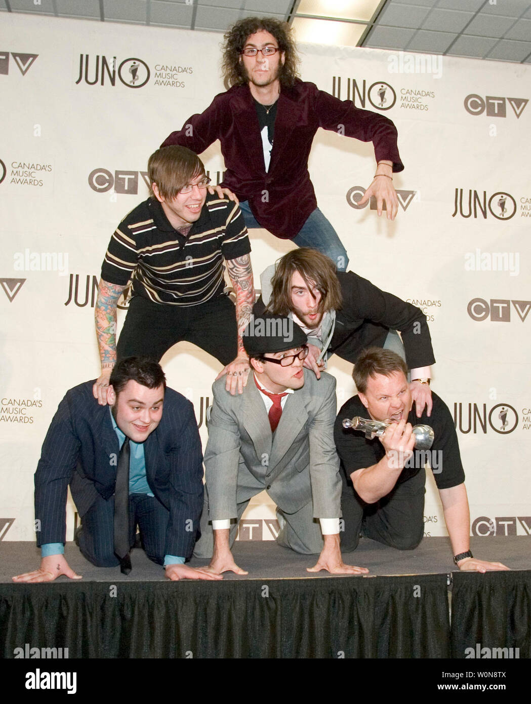 Members of the band Alexisonfire form a human pyramid with the help of ...