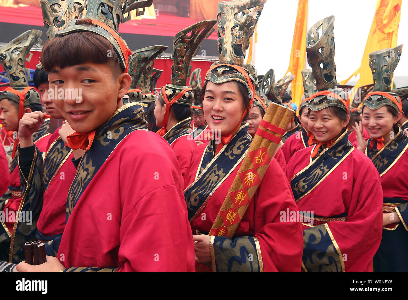 Chinese dancers dressed in imperial garb wait to perform in a public ...