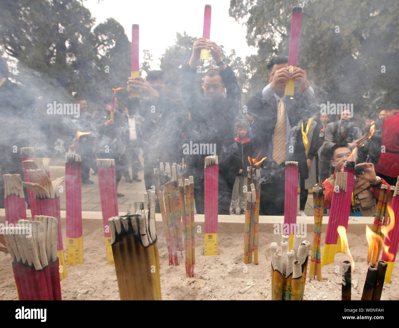 Chinese burn incense to honor the Yellow Emperor at a temple in Yan'an ...