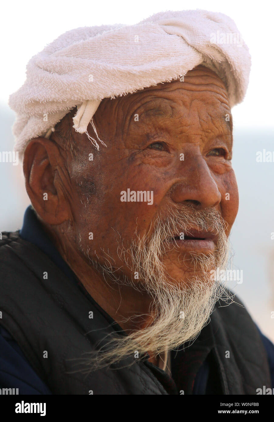 An elder watches Chinese from surrounding villages perform the famous ...