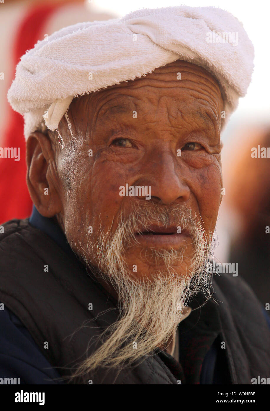 An elder watches Chinese from surrounding villages perform the famous ...